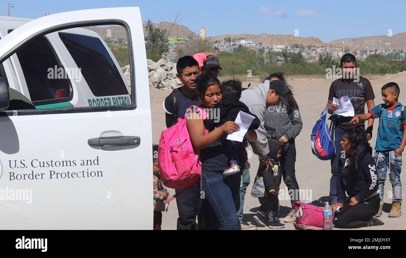 In this April 2019, frame from video, migrants turn themselves in to ...