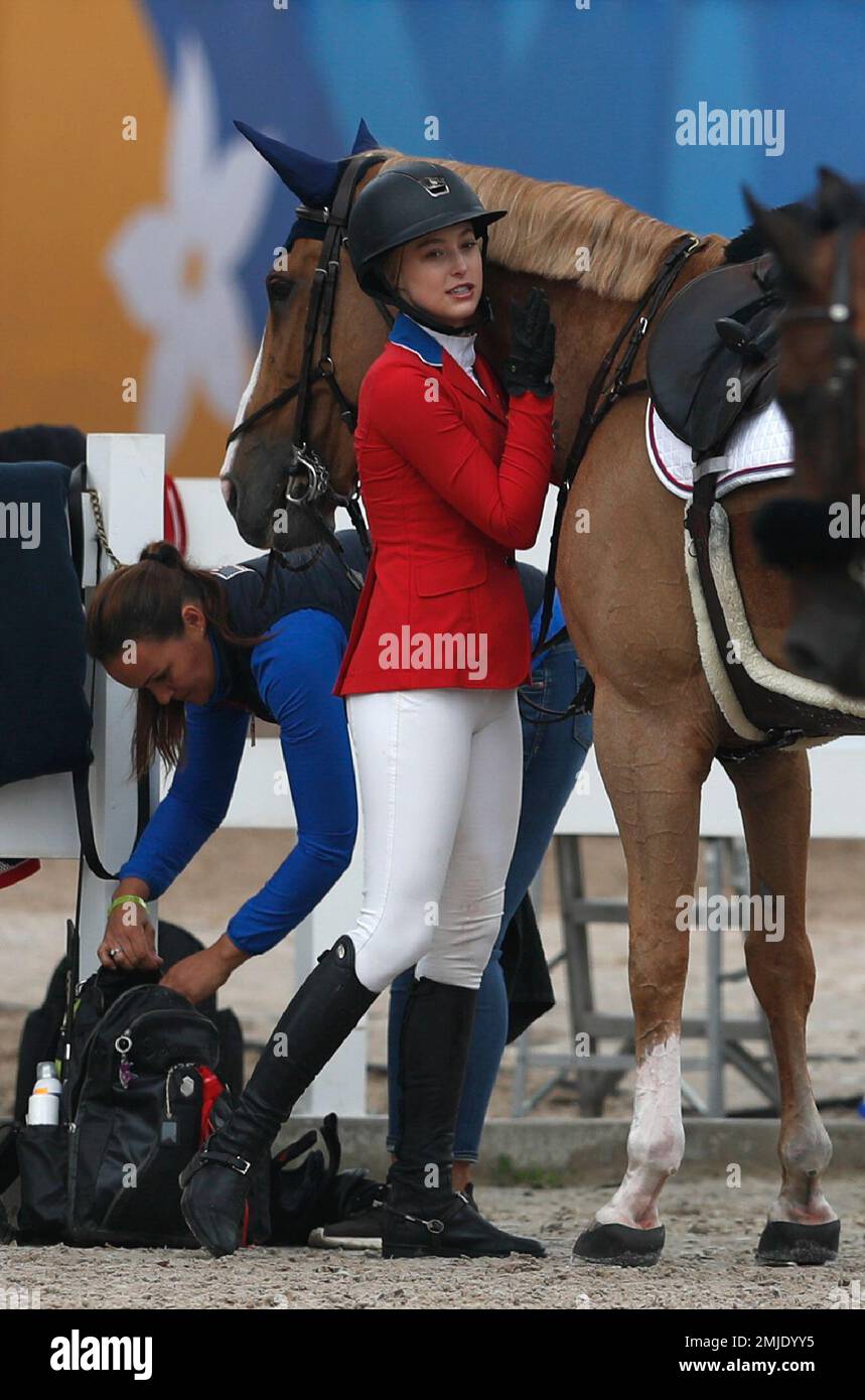 Eve Jobs of the U.S. pats her horse Venue d'Fees des Hazalles after competing in the first ...