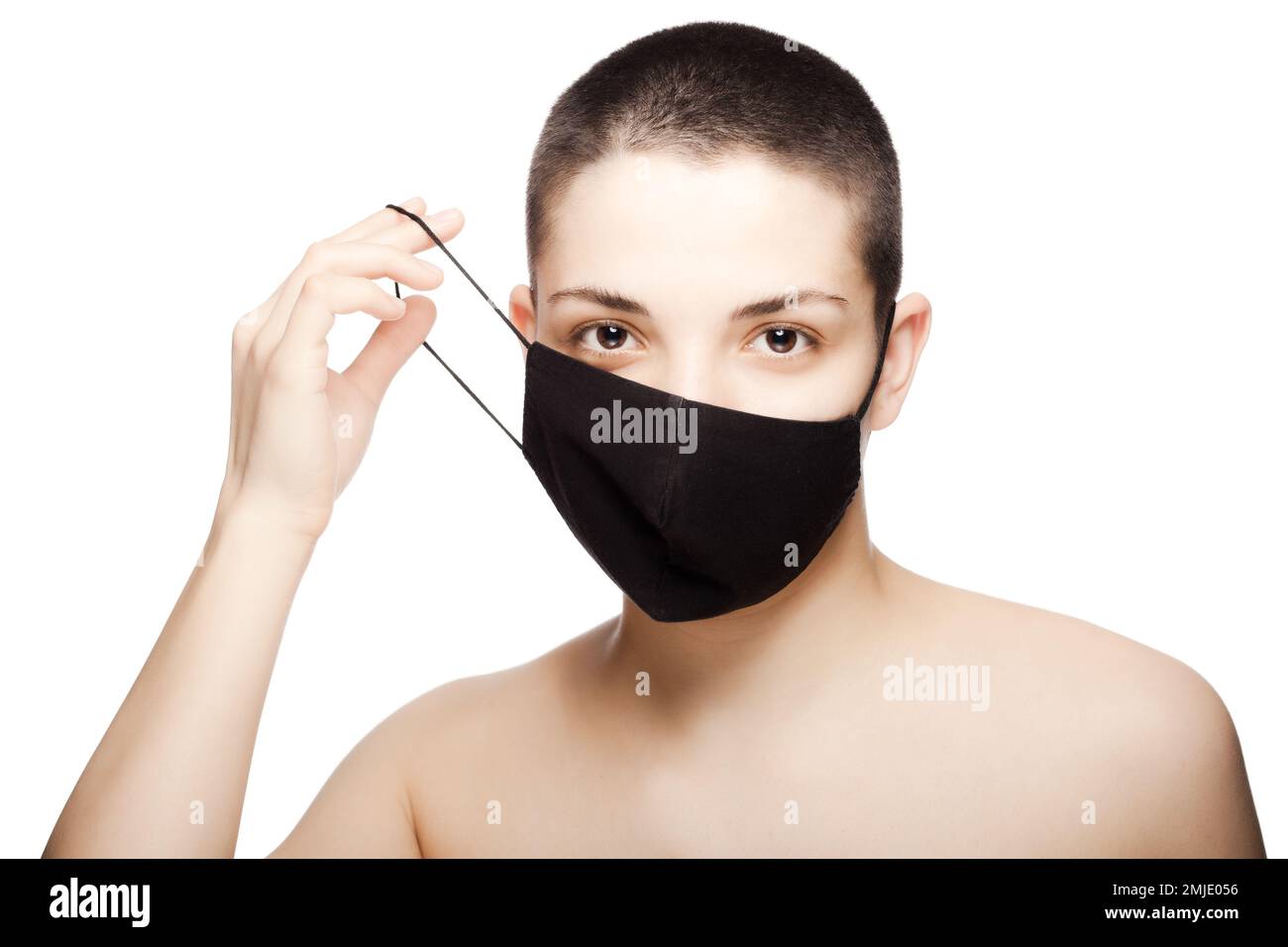 Cute girl with very short hair wearing black protective face mask ...