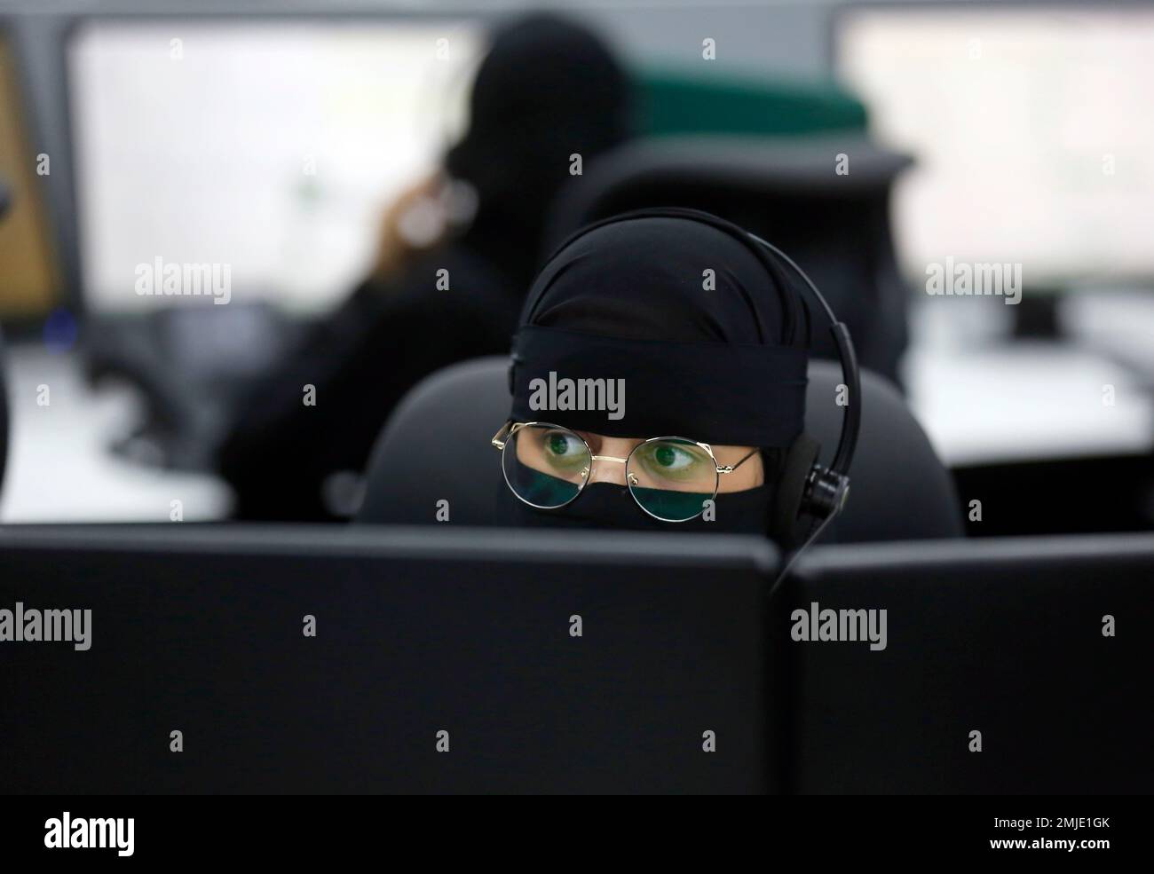 A Saudi police officer receives emergency calls at a call center, ahead ...