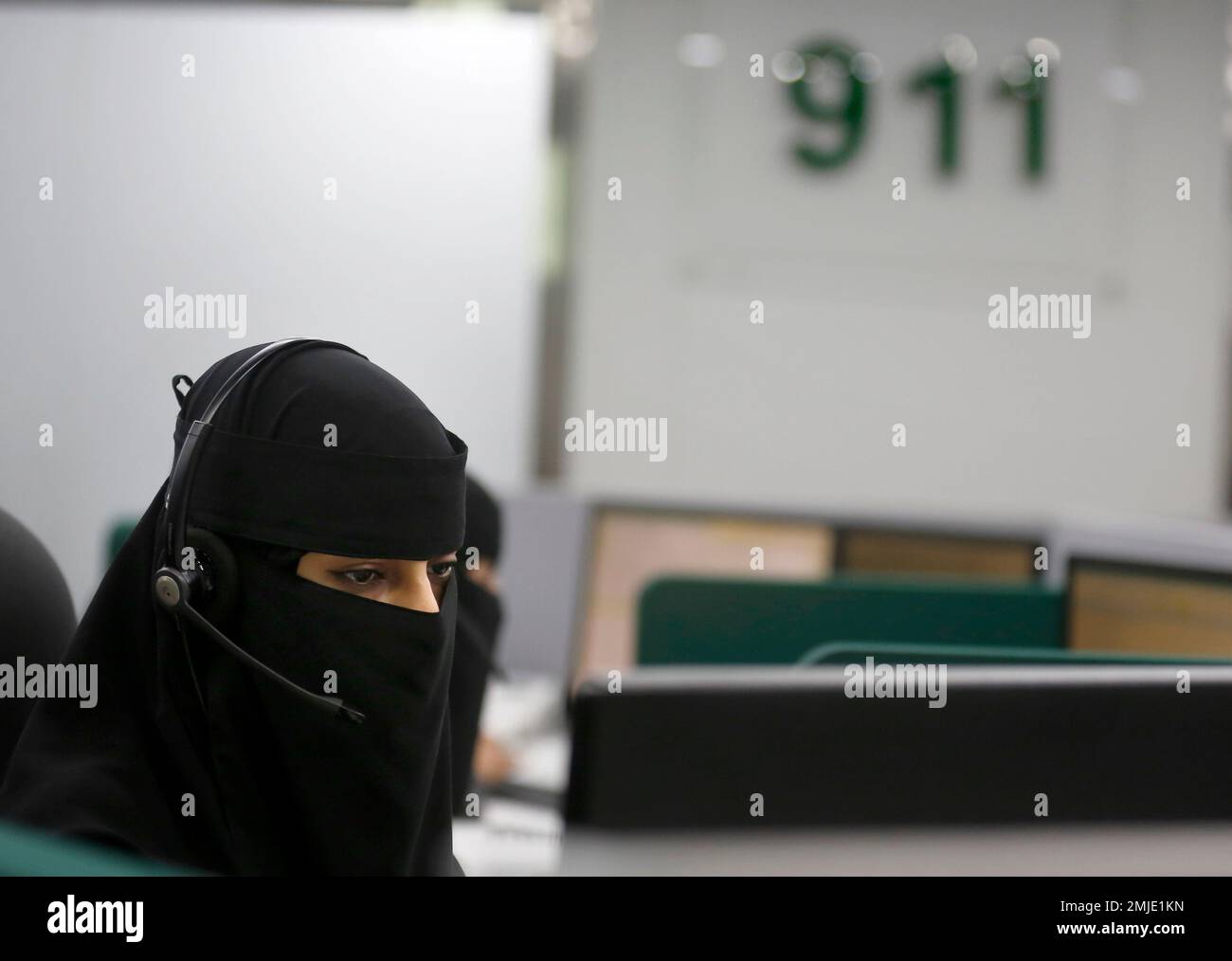 A Saudi police officer receives emergency calls at a call center, ahead ...