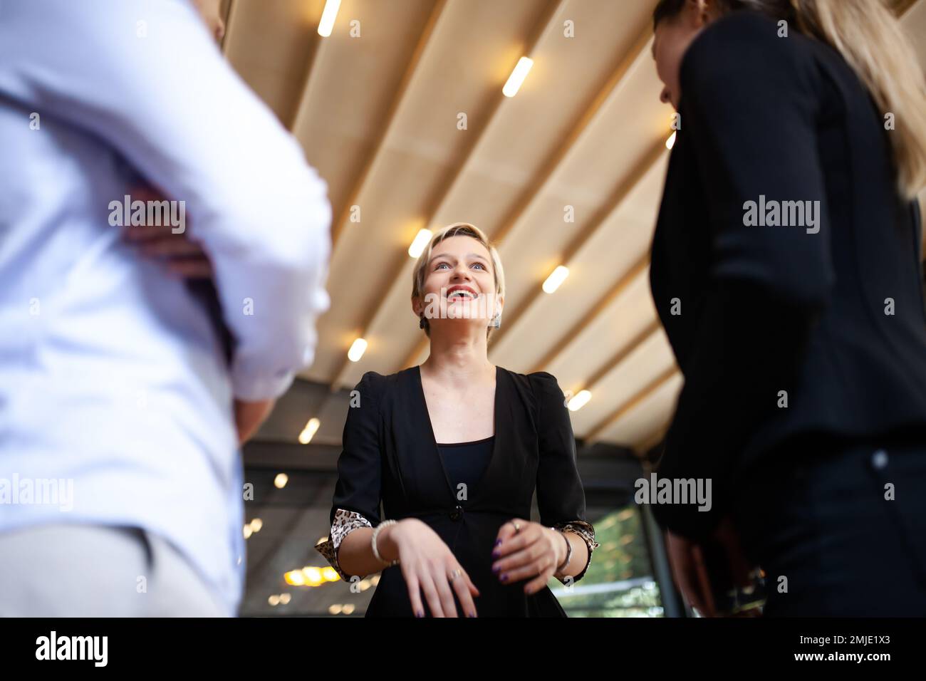 Three young business colleagues having fun conversation. Successfull ...