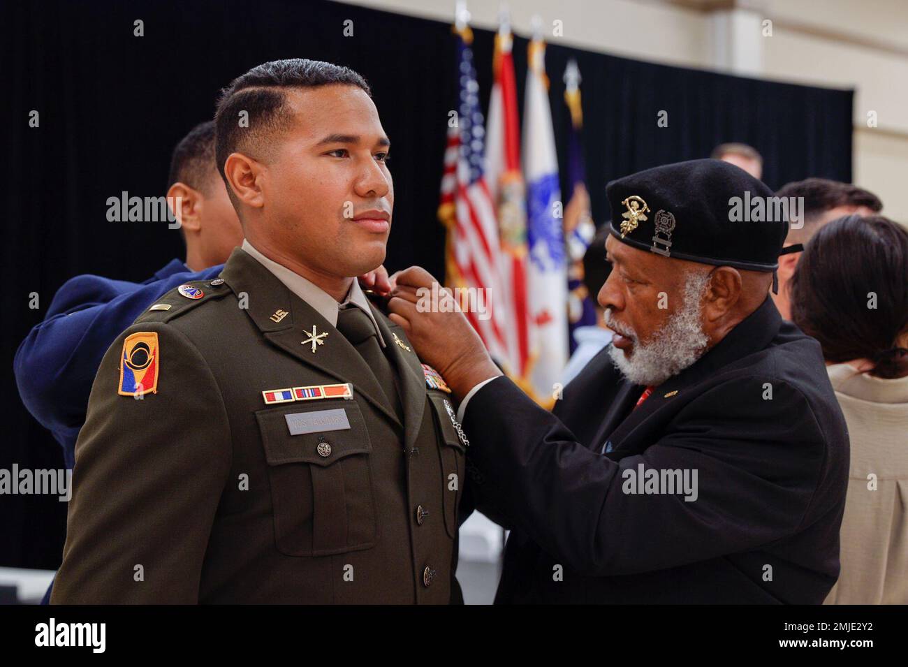 Officer Candidate Alexander Taujours, is pinned by his father during an ...