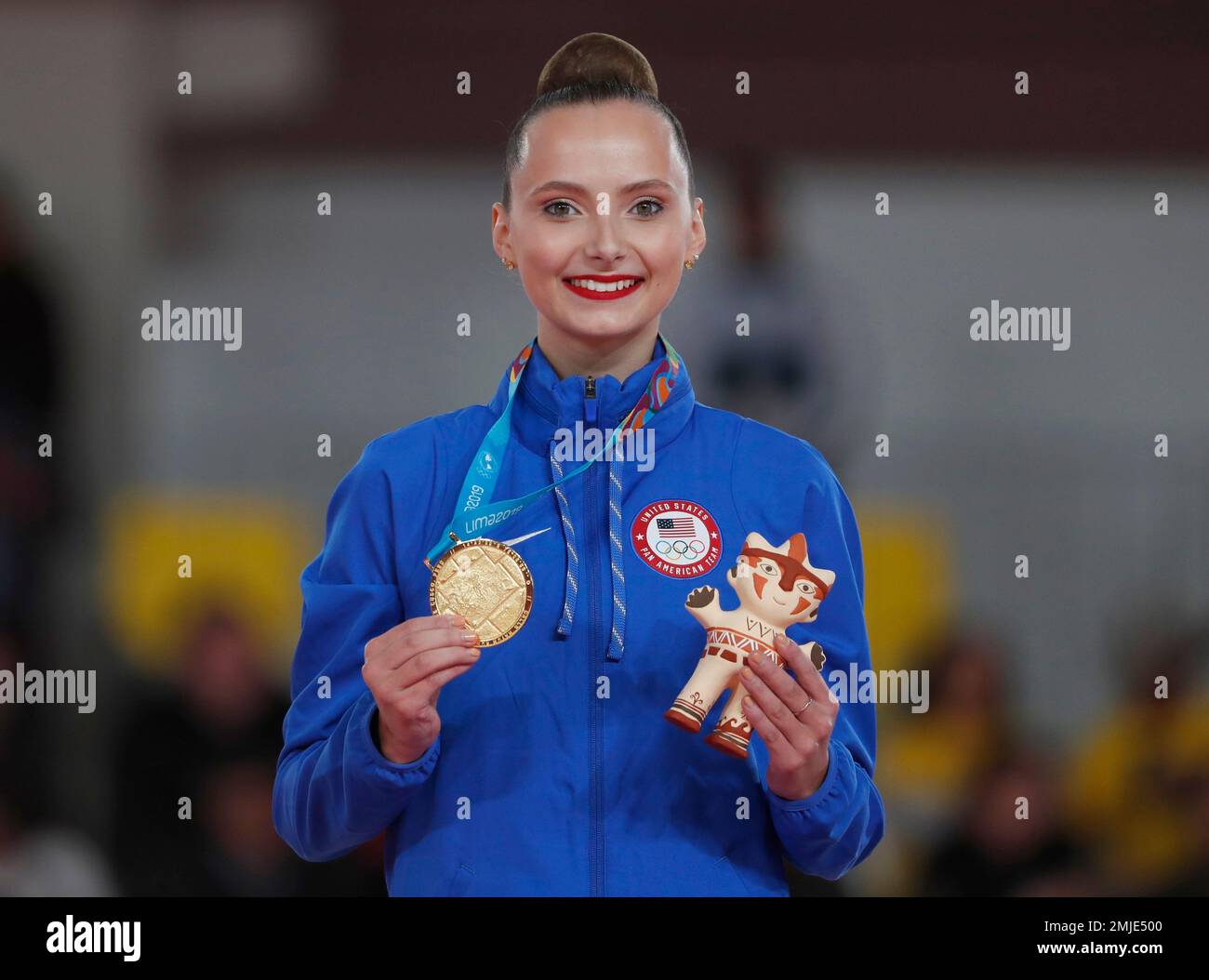 Camilla Feeley of the United States holds her gold medal for rhythmic ...