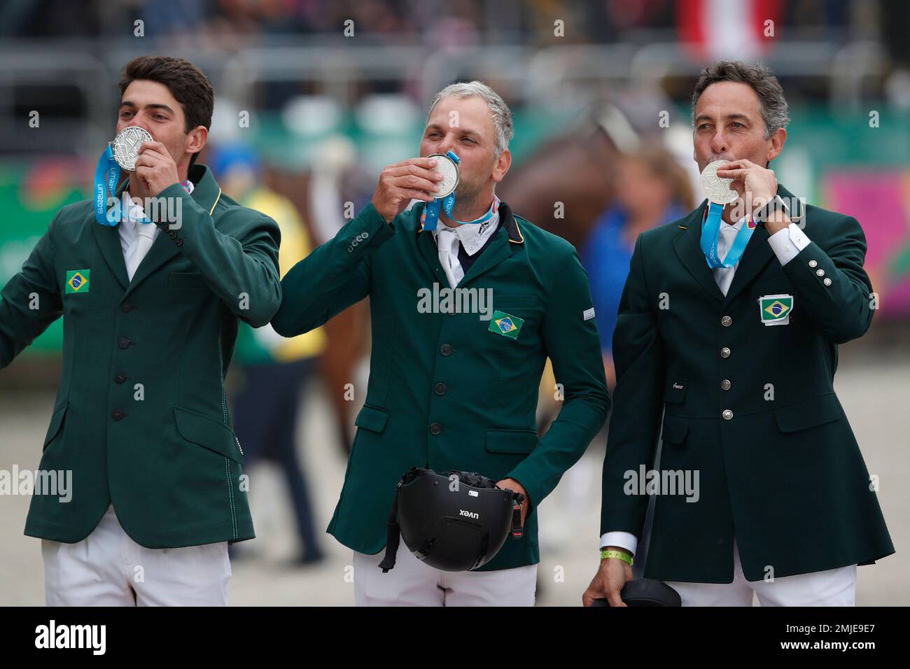 Brazil's equestrian team Carlos Parro, center, Marcelo Tosi, right, and ...