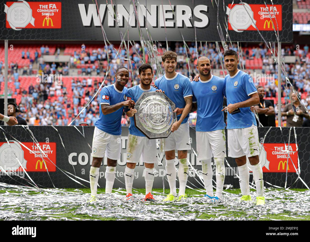 Manchester City's players pose with the trophy after the English ...