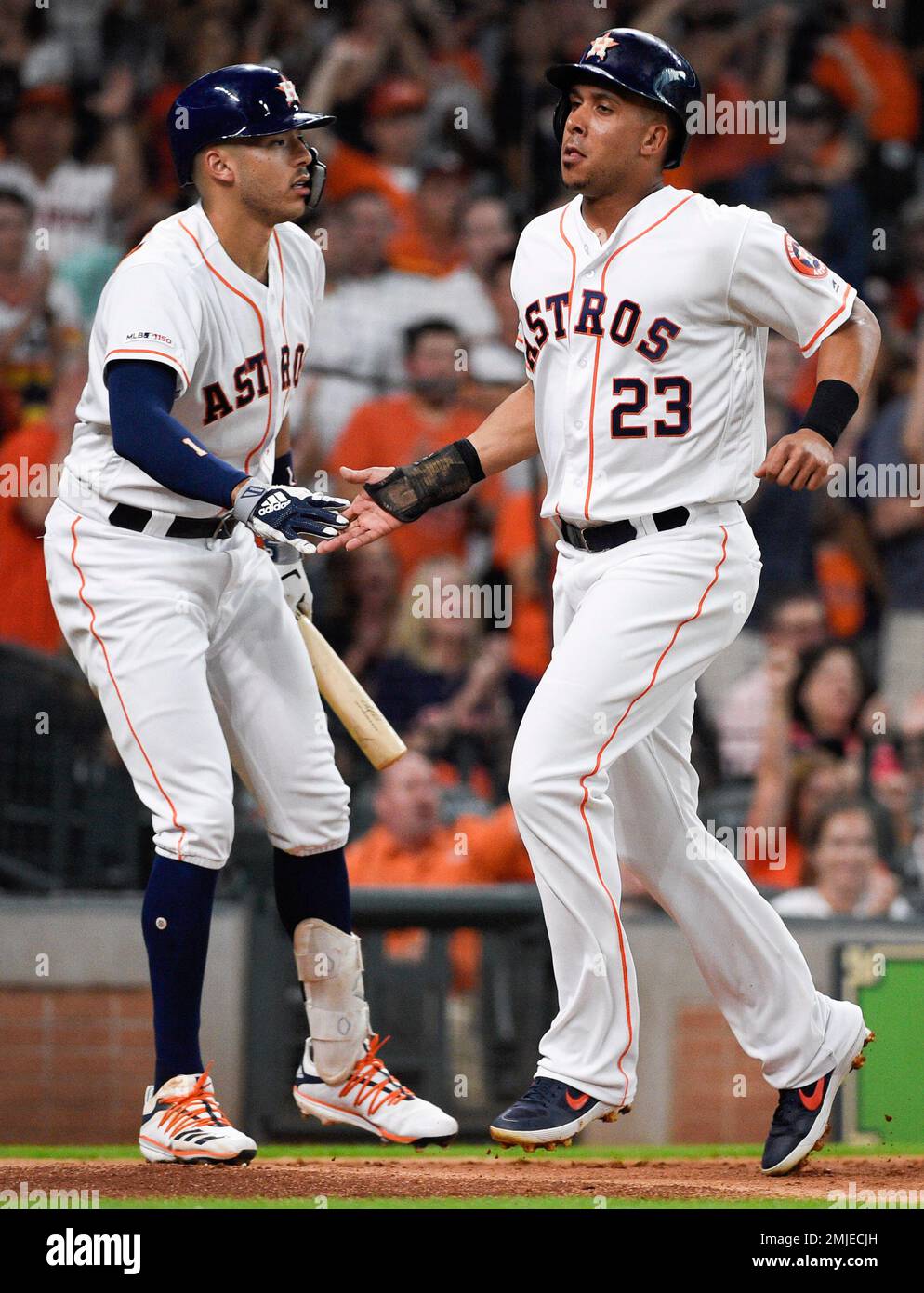 Houston Astros' Michael Brantley (23) celebrates with Carlos Correa ...