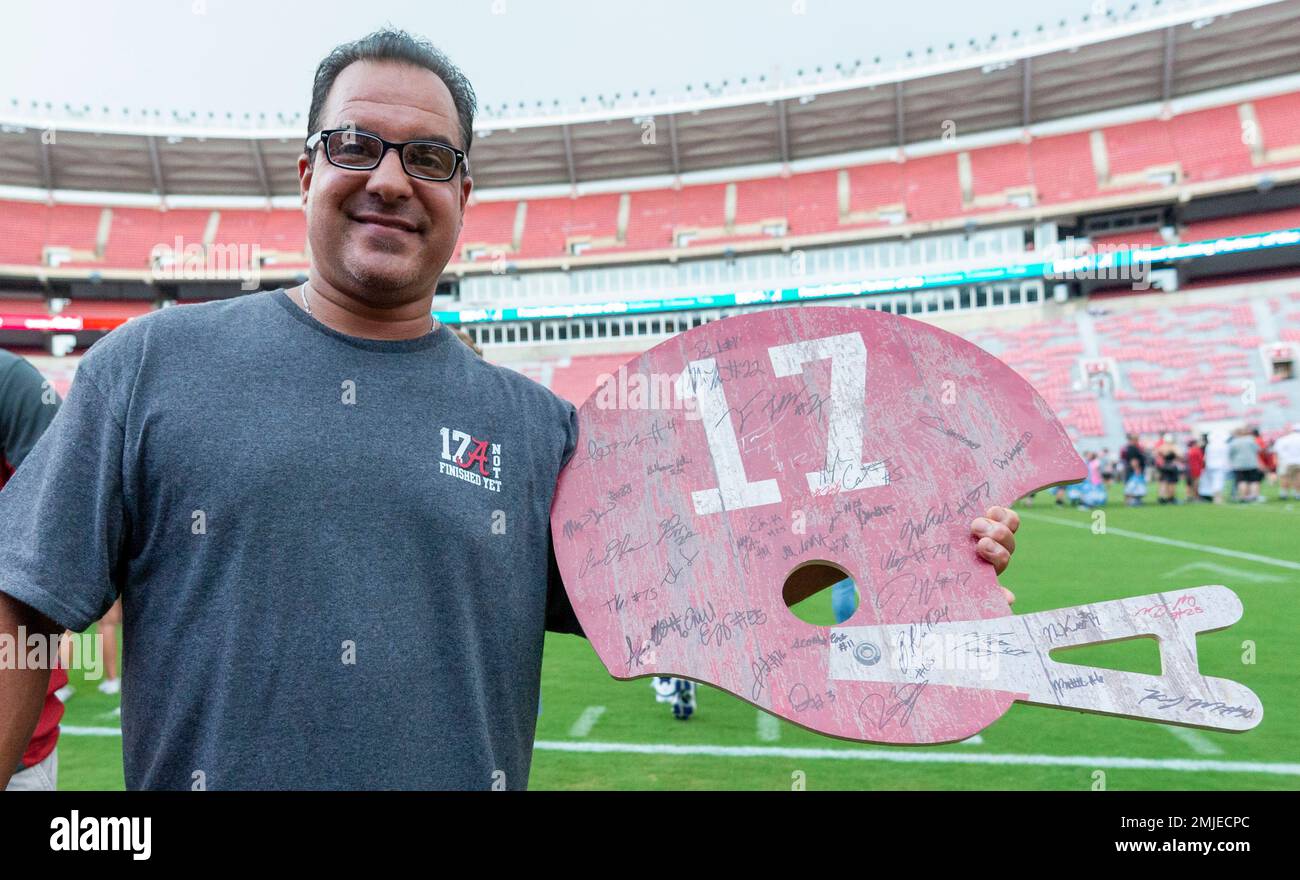 Thomas Kendrick, of Trussville, Ala., shows off his helmet-shaped ...