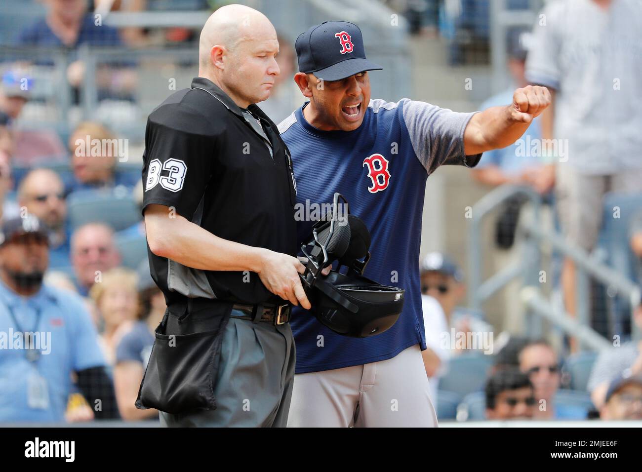 Boston Red Sox manager Alex Cora, left, reacts to umpire Mike Estabrook ...