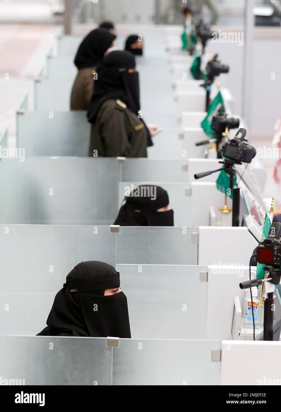 Saudi female officers from, the national security forces, wait for ...