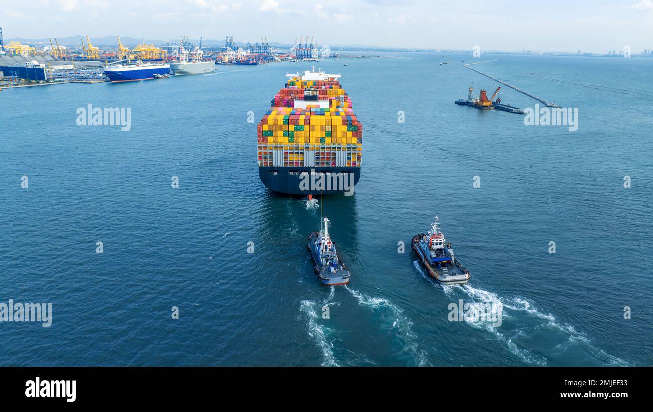 Tub Boat with Stern of cargo ship carrying container and running for ...