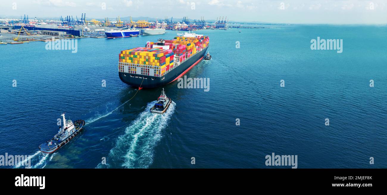 Tub Boat with Stern of cargo ship carrying container and running for ...