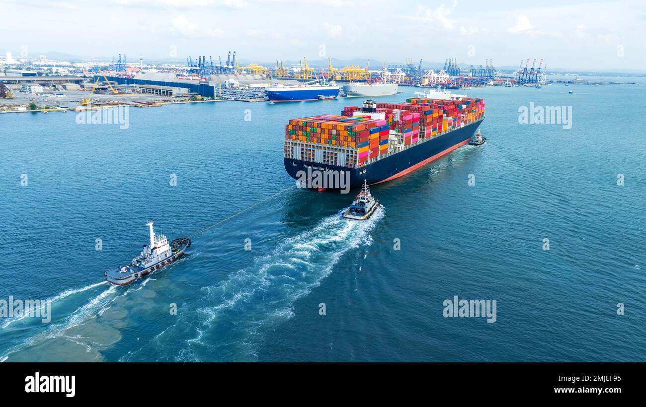 Tub Boat with Stern of cargo ship carrying container and running for ...