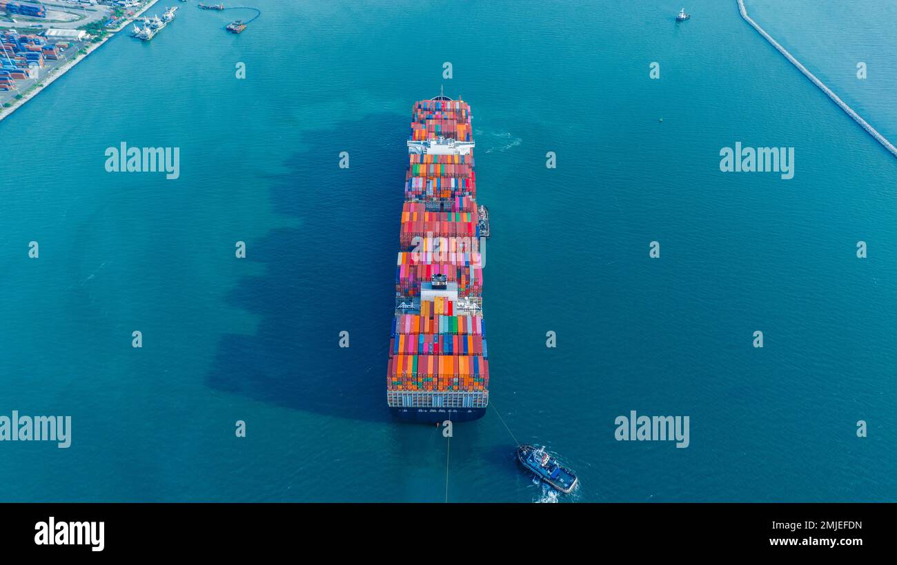 Tub Boat with Stern of cargo ship carrying container and running for ...