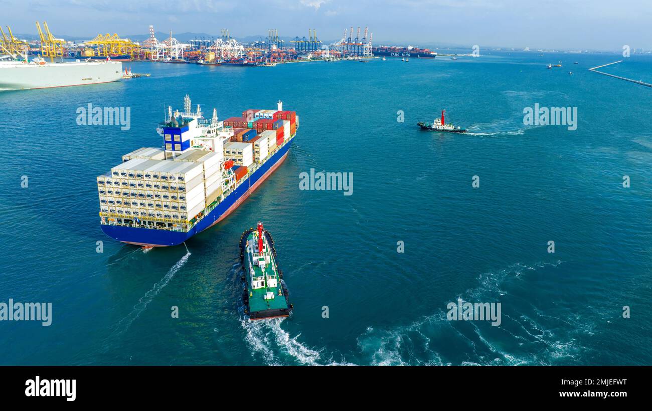 Tub Boat with Stern of cargo ship carrying container and running for ...