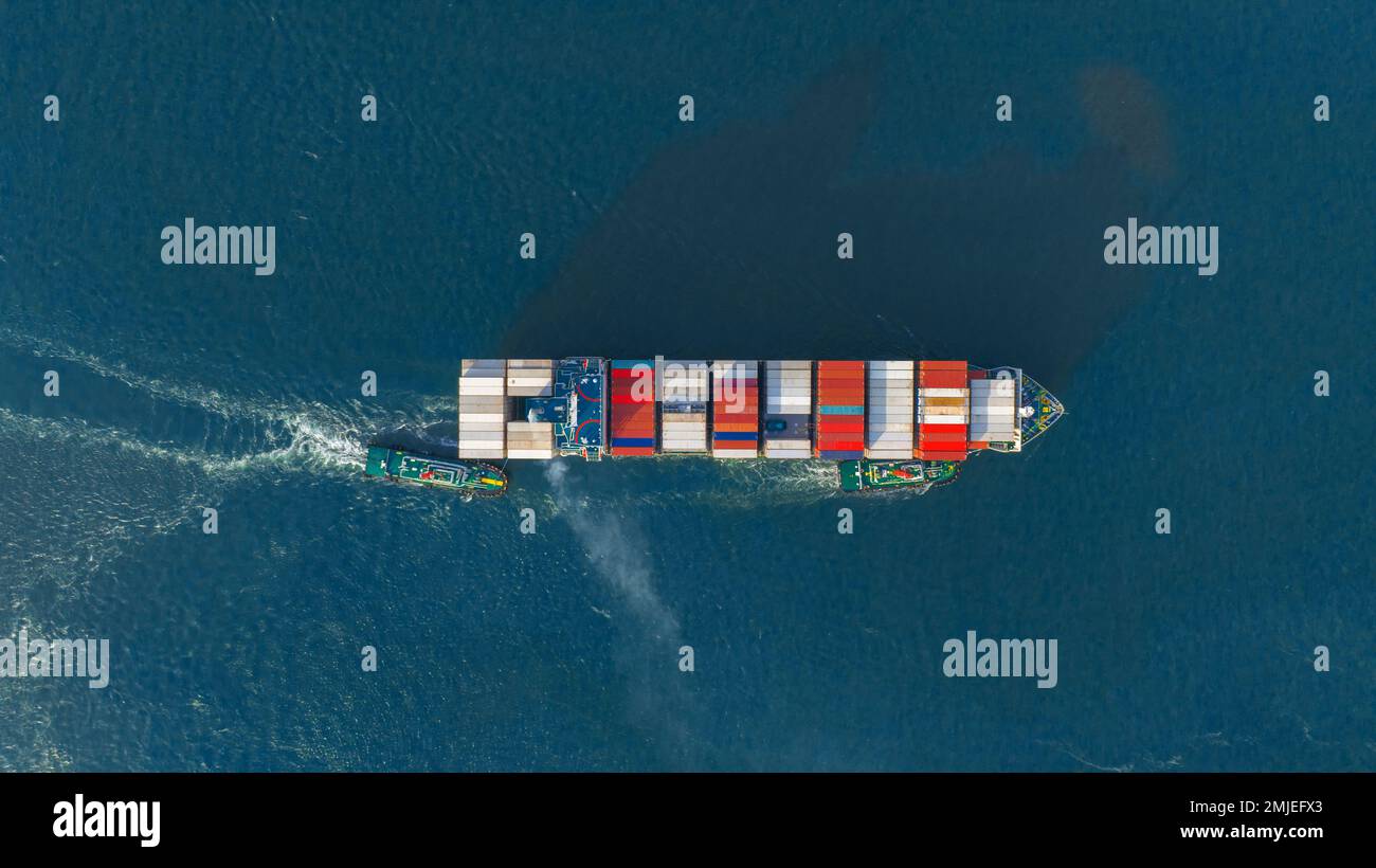 Tub Boat with Stern of cargo ship carrying container and running for ...