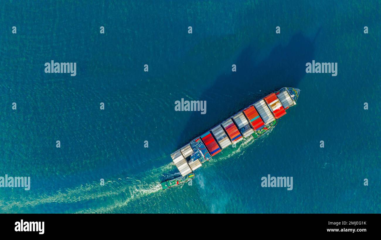 Tub Boat with Stern of cargo ship carrying container and running for ...