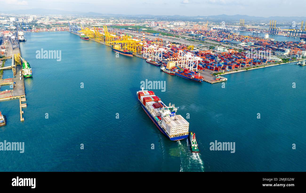 Tub Boat with Stern of cargo ship carrying container and running for ...