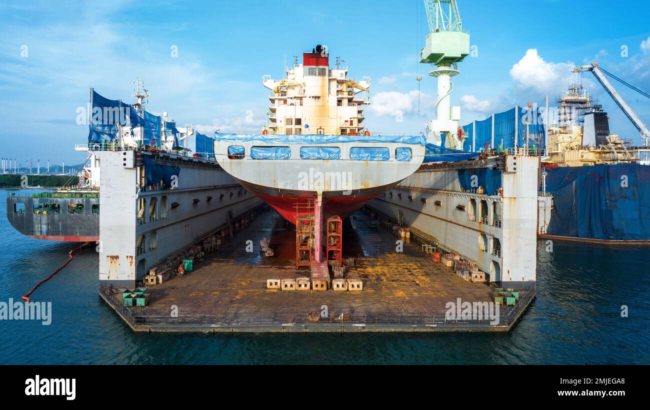 cargo container ship at dry dock concept maintenance service working in ...