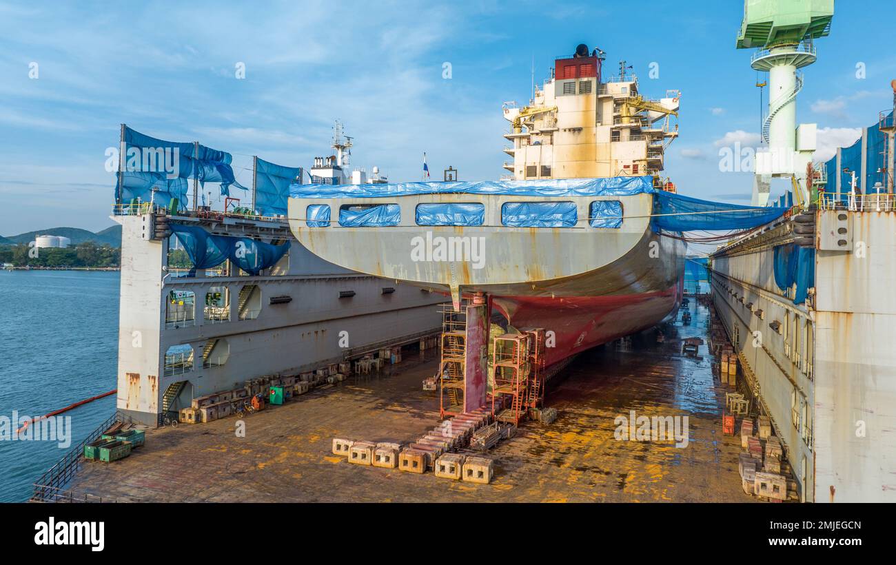 cargo container ship at dry dock concept maintenance service working in ...
