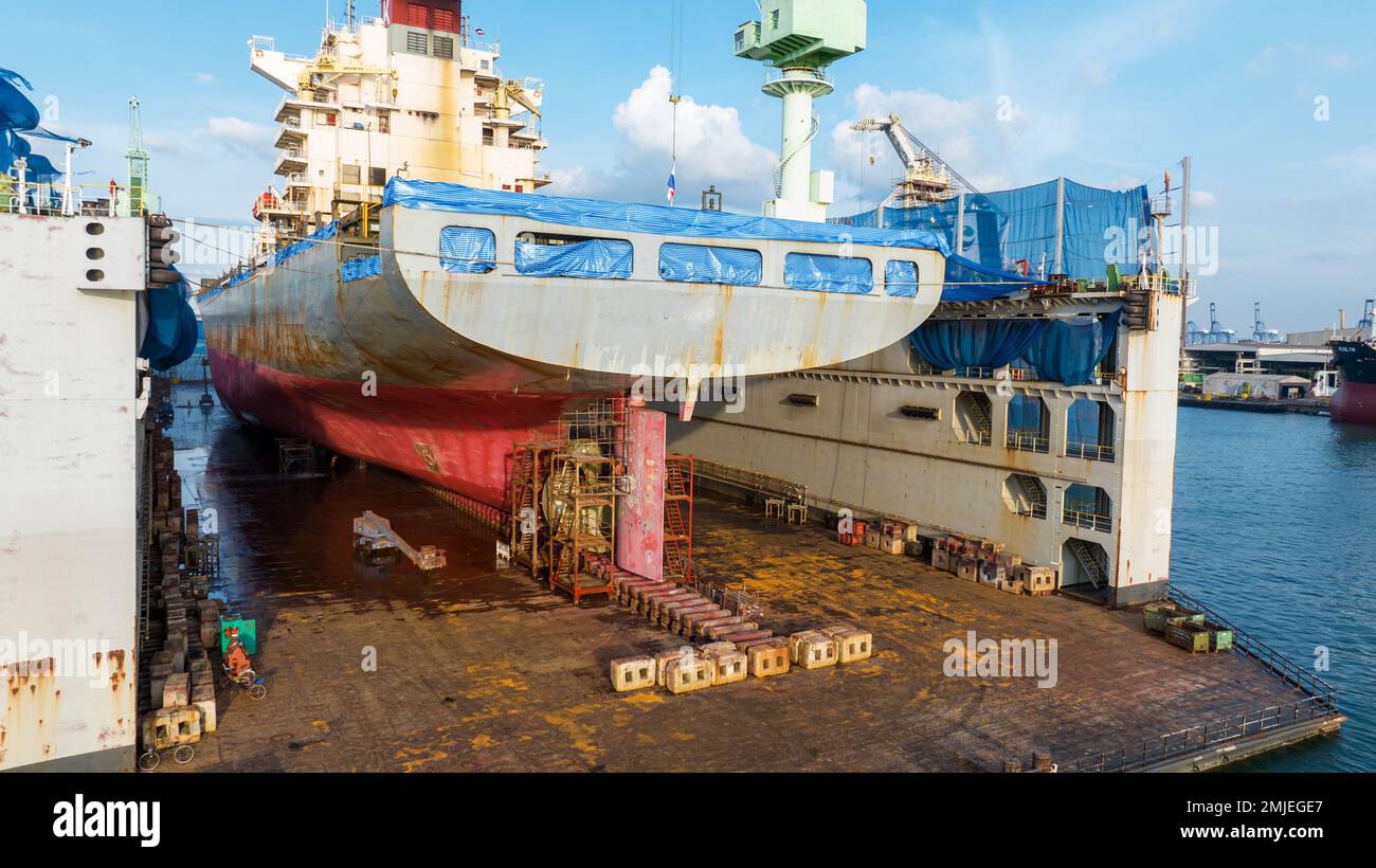 cargo container ship at dry dock concept maintenance service working in ...