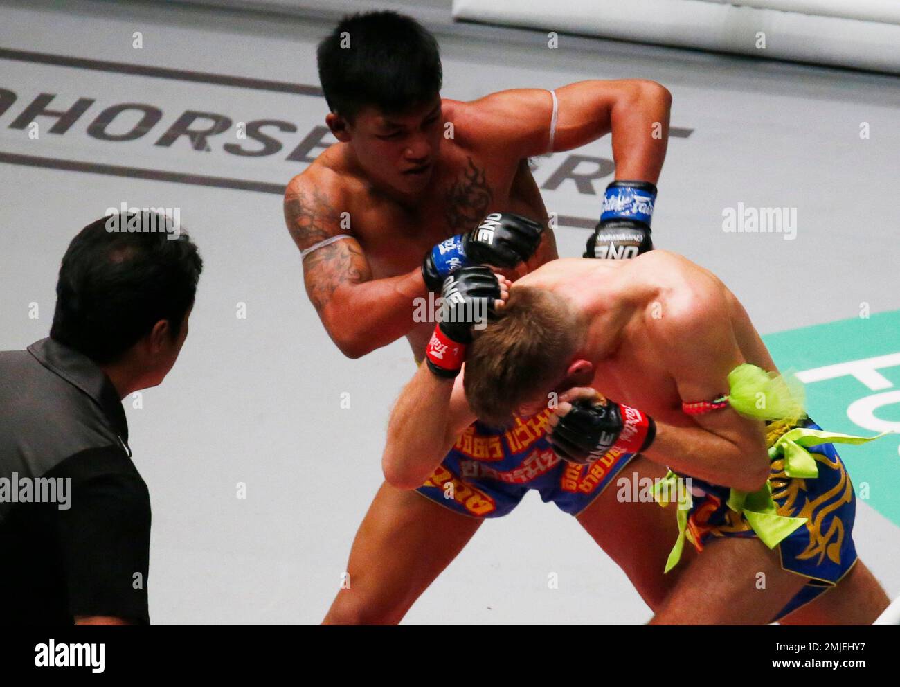 Challenger Rodtang Jitmuangnon, top, of Thailand delivers a barrage of ...