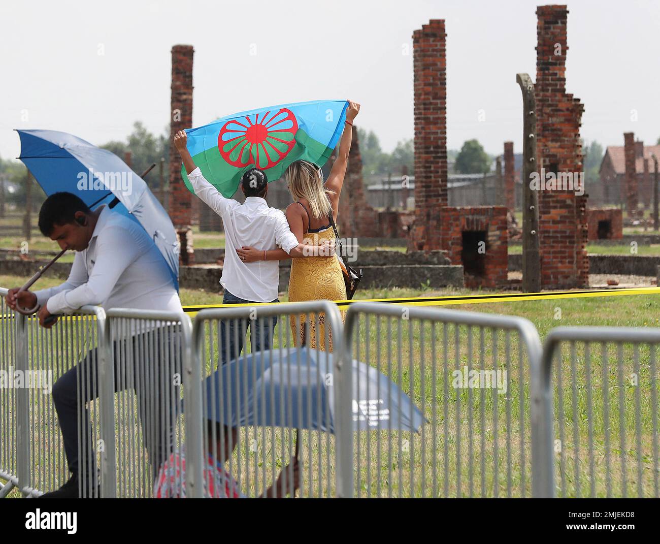 People display a Romani flag to commemorate the Roma and Sinti people ...
