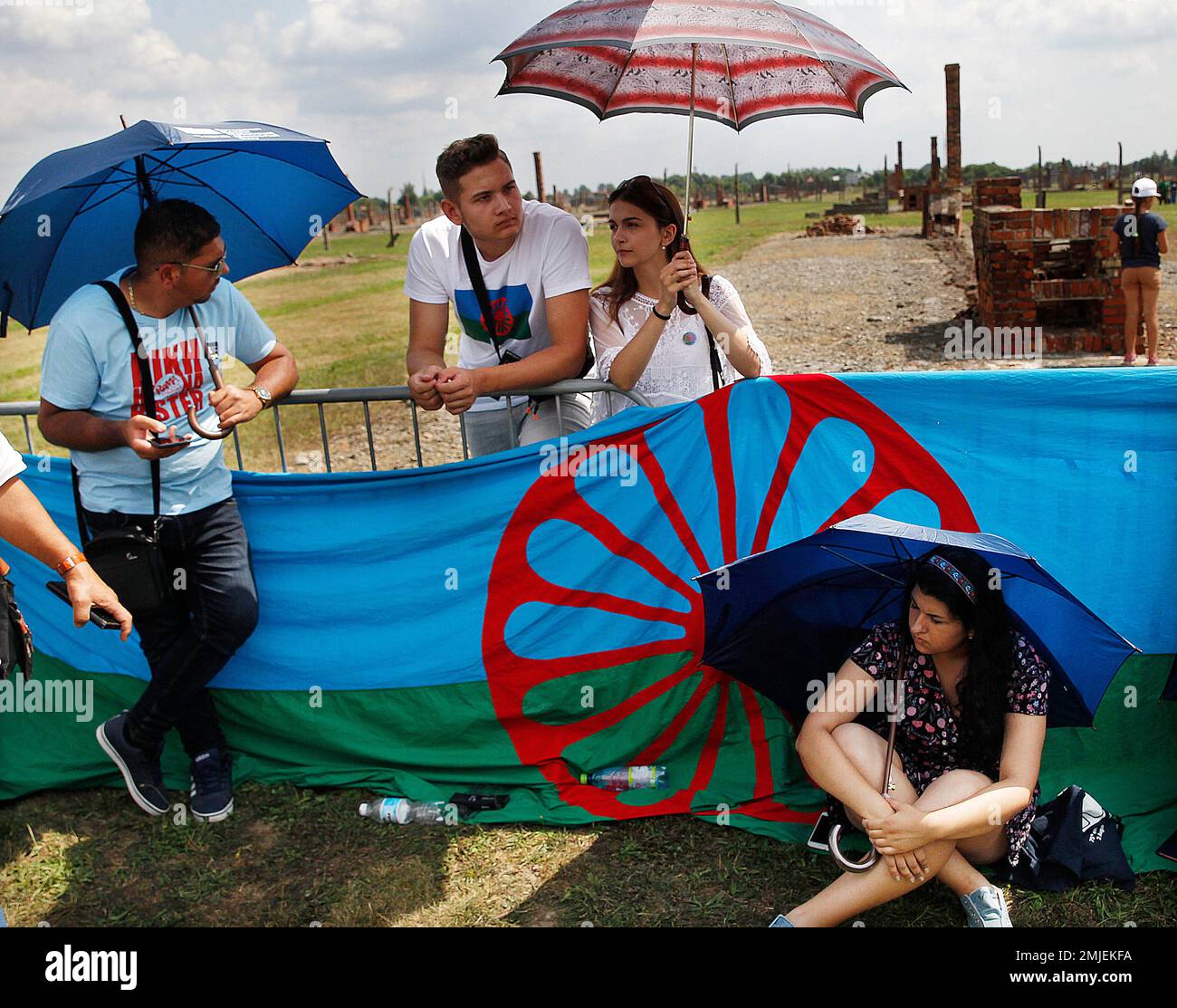 People display a Romani flag to commemorate the Roma and Sinti people ...