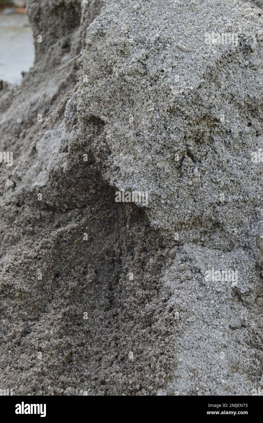 portrait of gray sand dunes as a raw material for building (walls ...