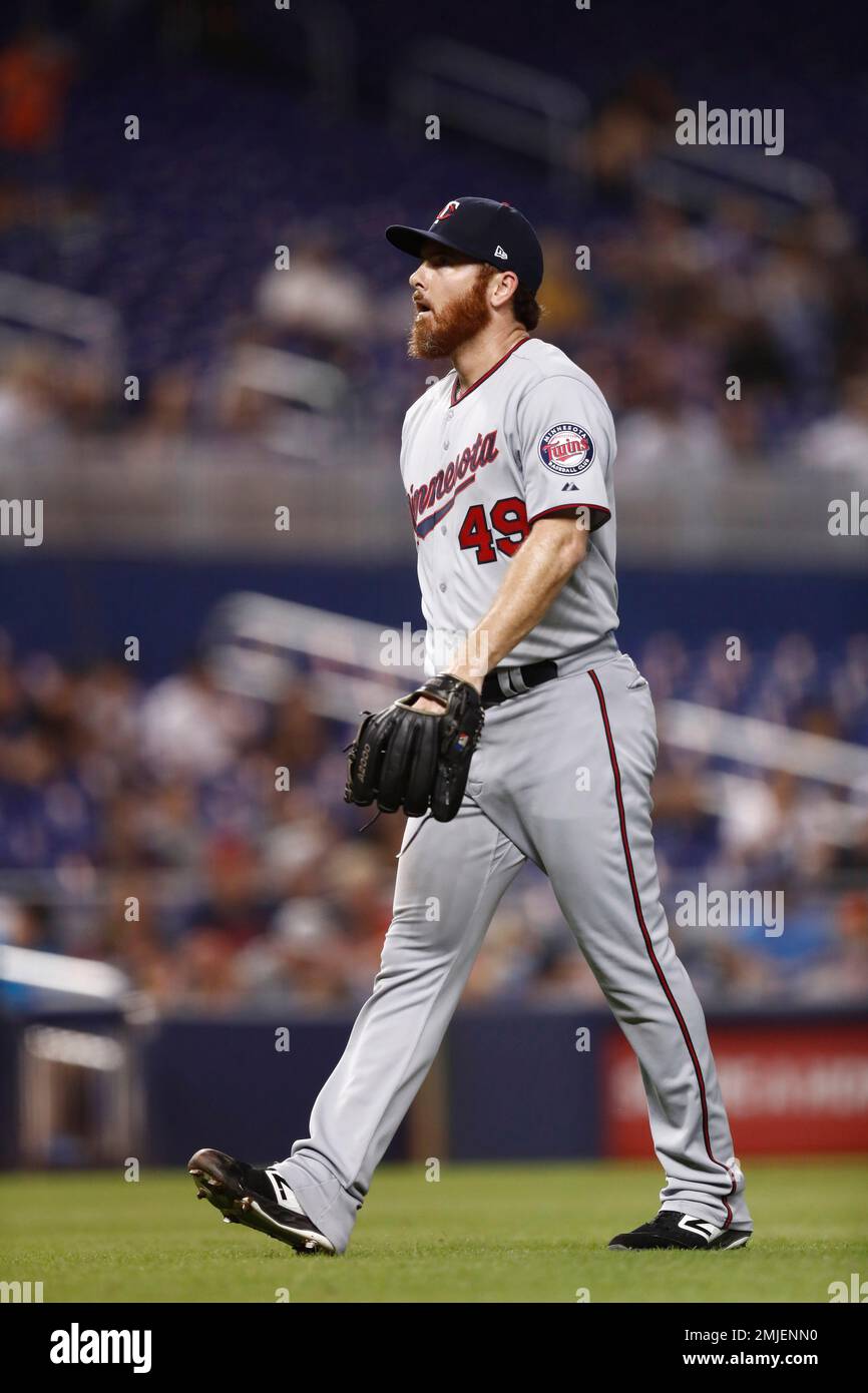 Minnesota Twins relief pitcher Sam Dyson walks off the field during the ...