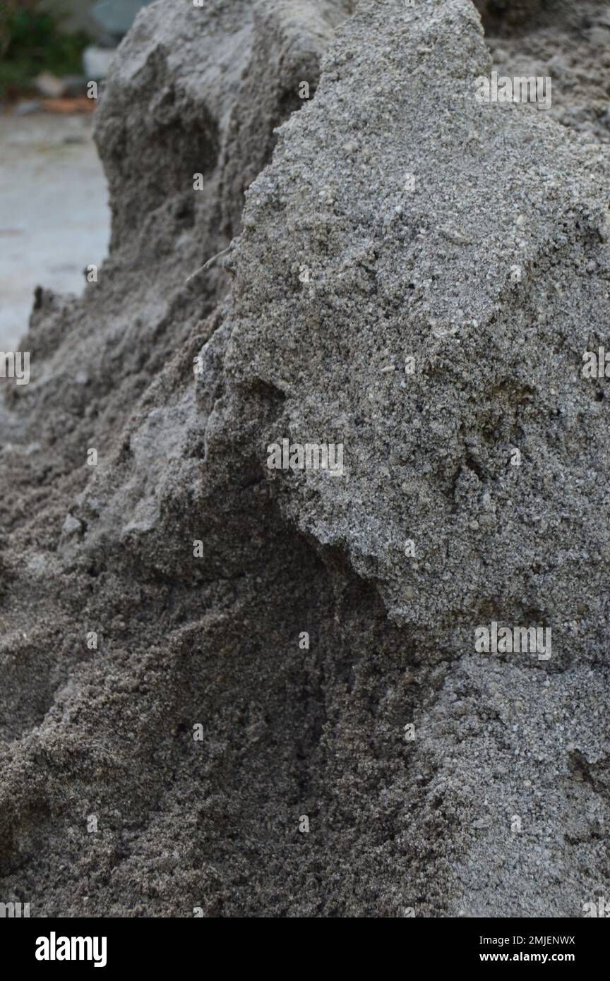 portrait of gray sand dunes as a raw material for building (walls ...