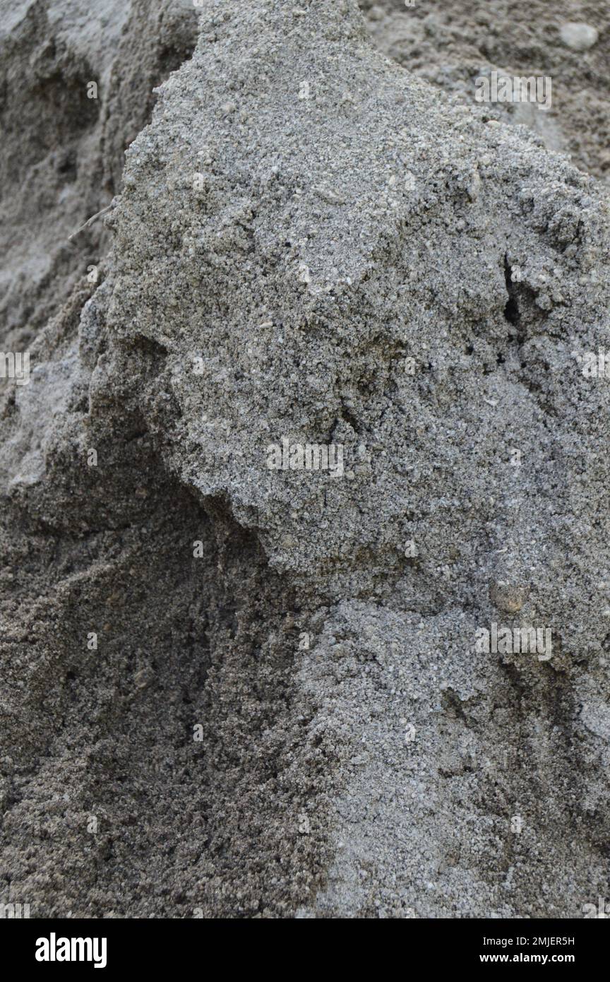 portrait of gray sand dunes as a raw material for building (walls ...