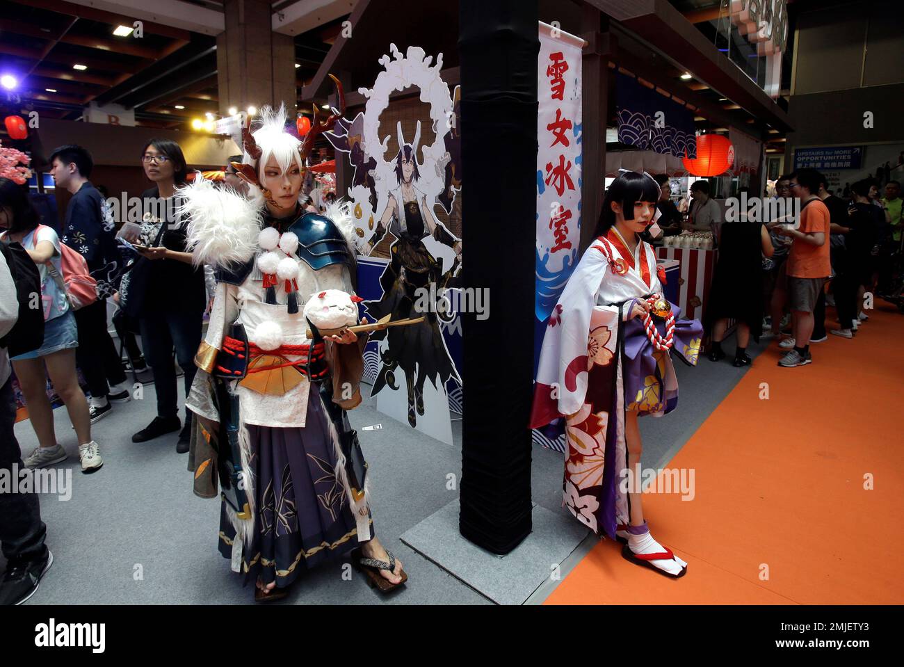 Showgirls dressed in cosplay costumes pose at the 2019 Comic Exhibition ...