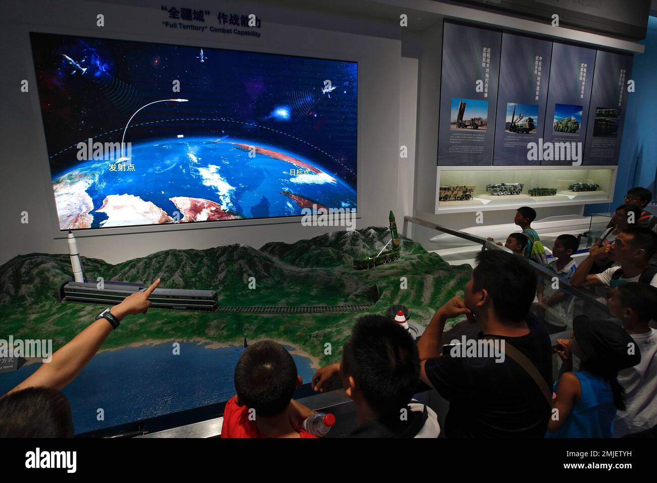 Visitors watch a TV screen showing a ballistic missile target at a ...