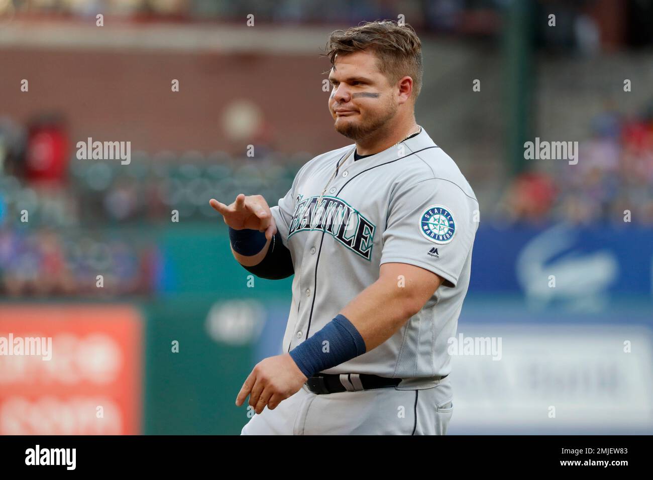 Seattle Mariners' Daniel Vogelbach gestures as he walks across the ...