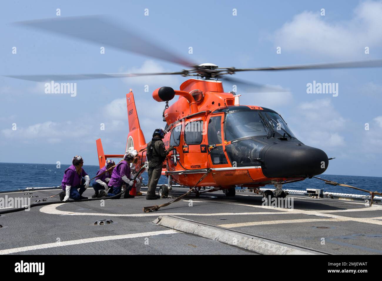 USCGC Mohawk (WMEC 913) crew members fuel the a MH-65 Dolphin ...