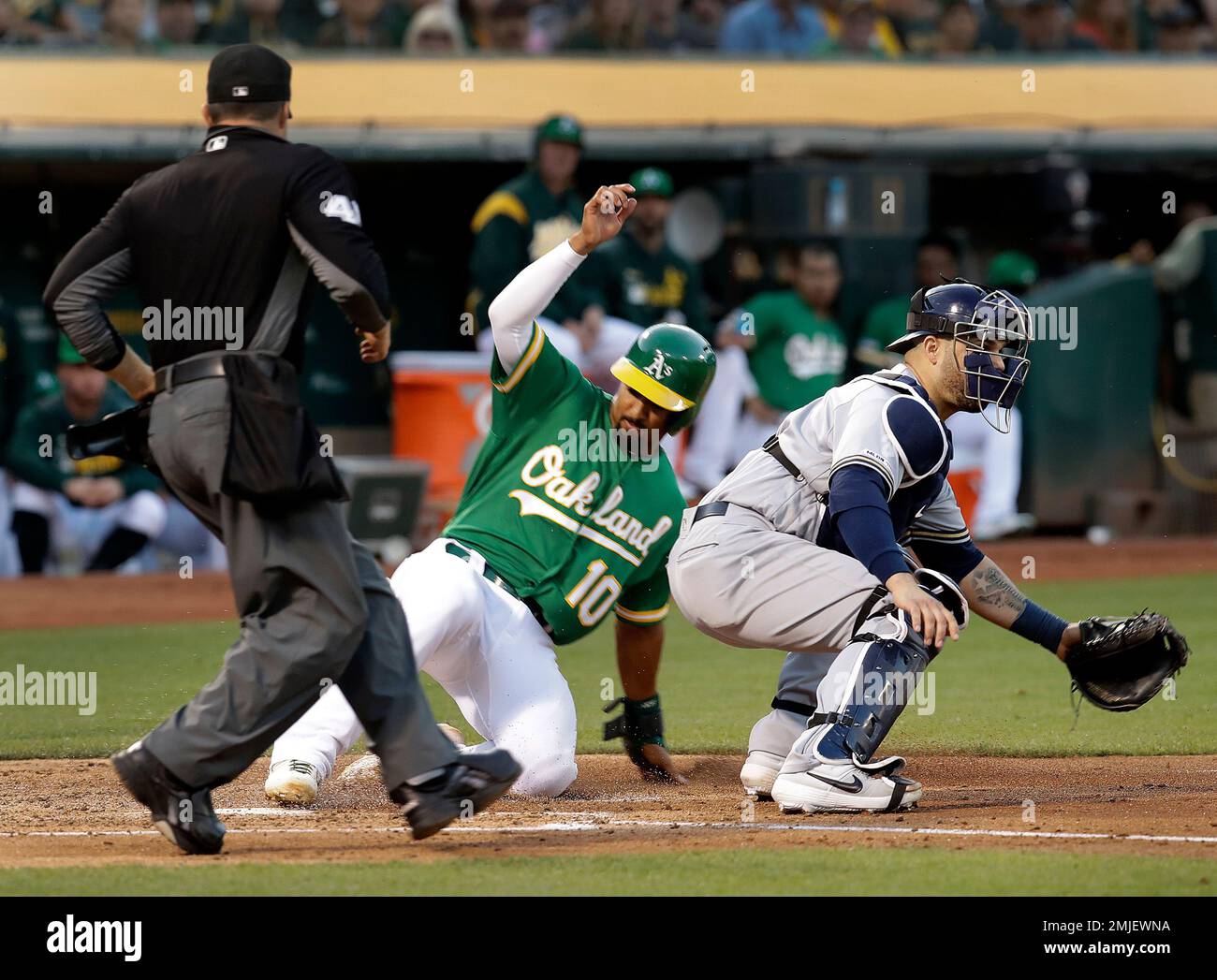 Oakland Athletics' Marcus Semien (10) scores past Milwaukee Brewers catcher Manny Pina during ...