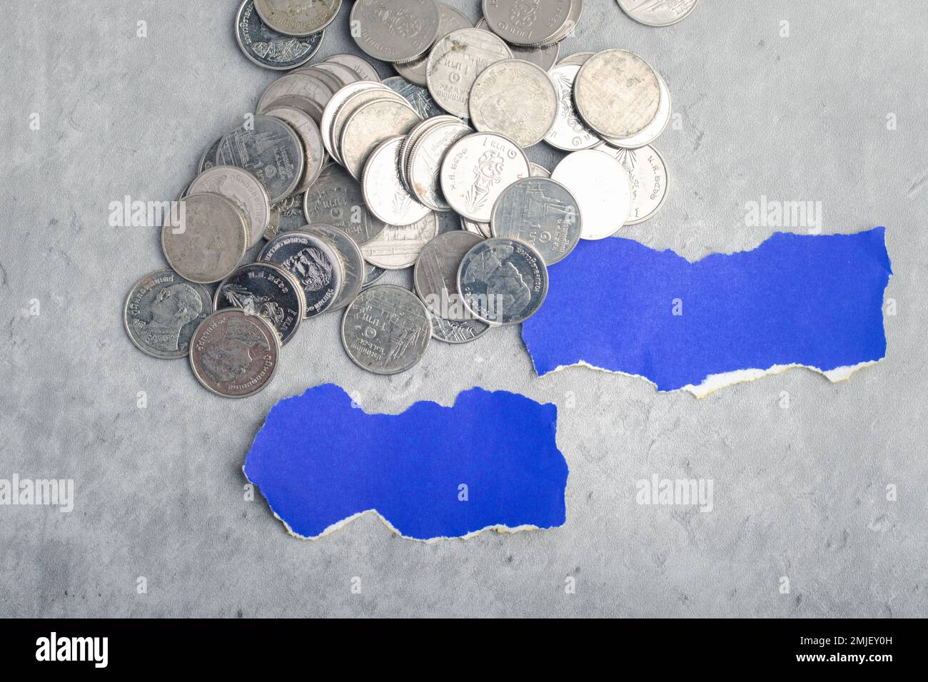 Torn paper with coins for copy space Stock Photo - Alamy