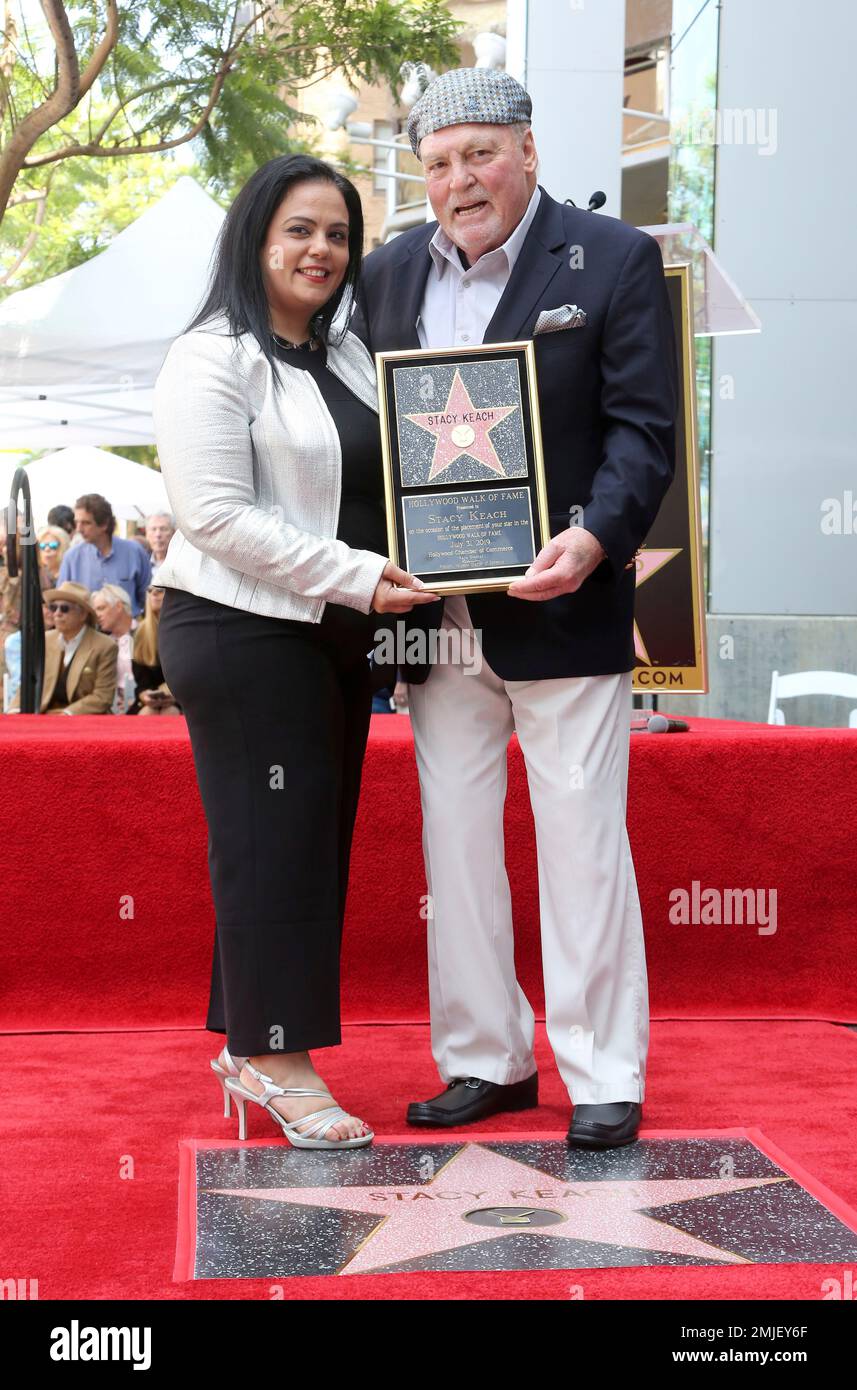 Stacy Keach, left, and Malgosia Tomassi Keach hold a miniaturette of a ...