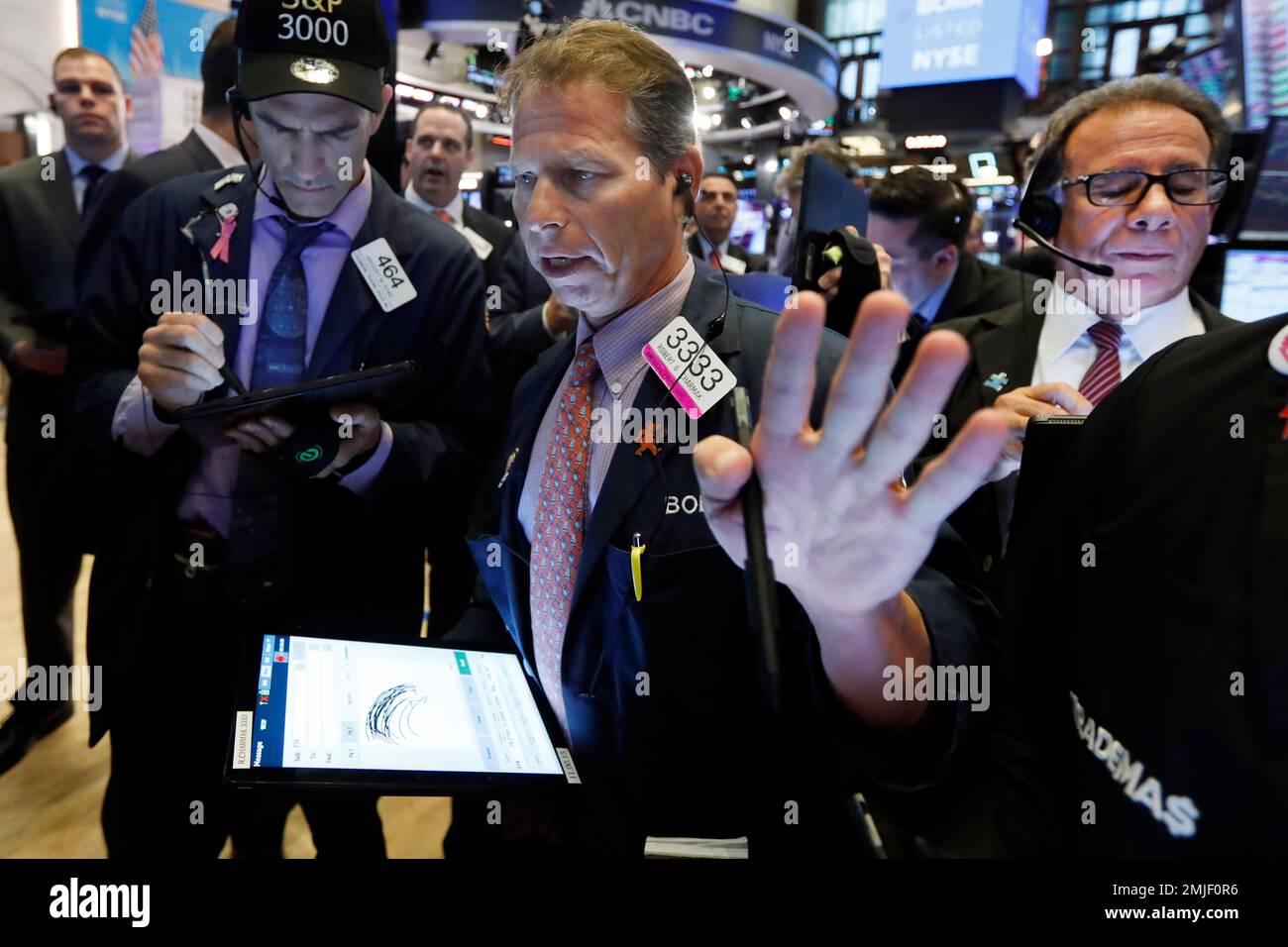 Trader Robert Charmak, center, works on the floor of the New York Stock ...