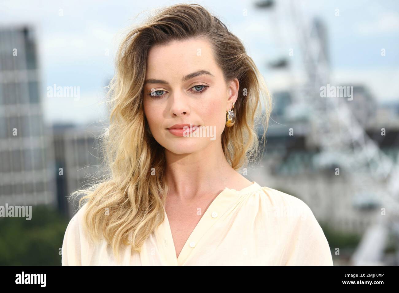 Actress Margot Robbie poses for photographers upon arrival at the UK ...
