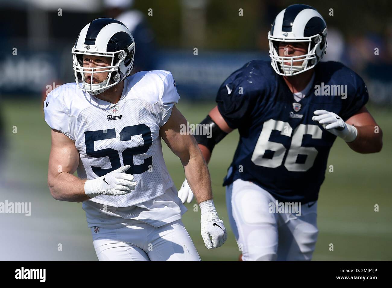 Los Angeles Rams linebacker Clay Matthews, left, runs ahead of center ...