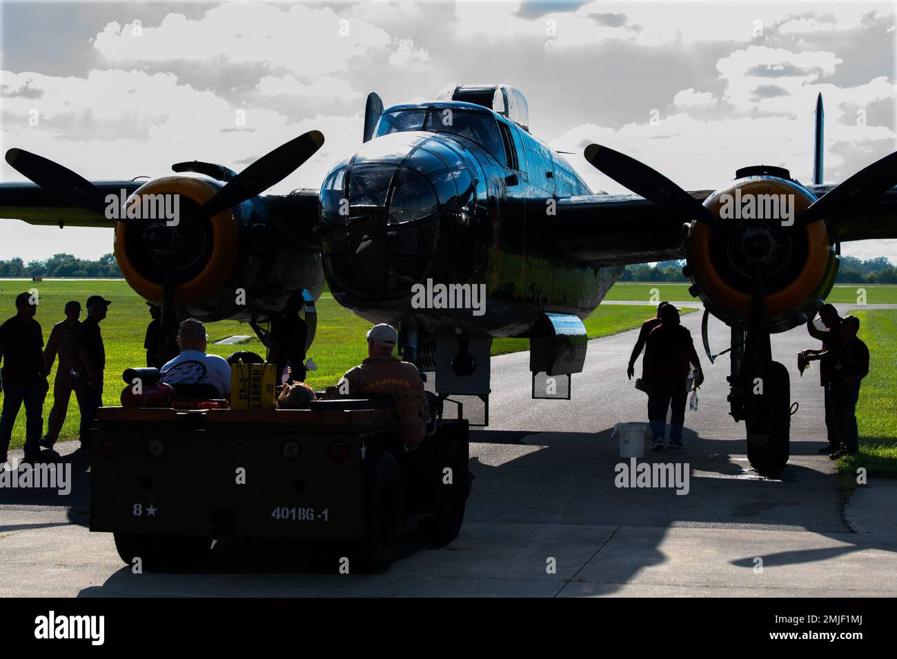 A ground crew of volunteers clean oil from the Champaign Gal’s engine ...