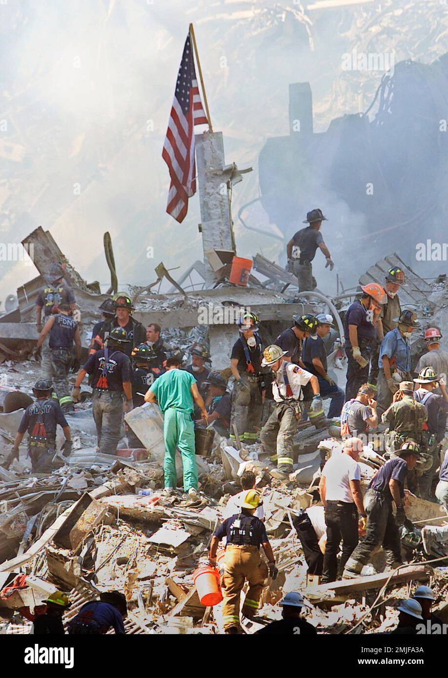 FILE - In this Sept. 13, 2001 file photo, rescue workers climb on piles ...