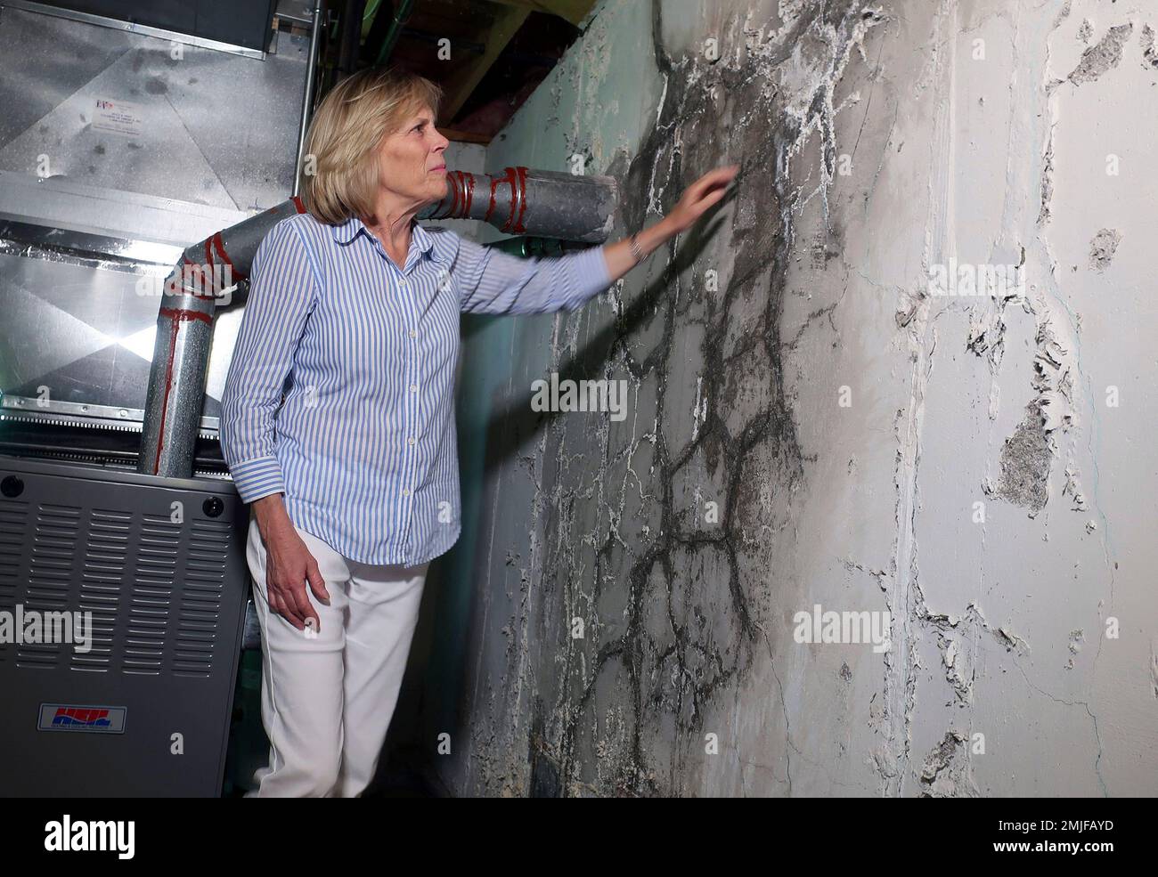 In this July 1, 2019 photo, Wendy Padula touches the crumbling ...