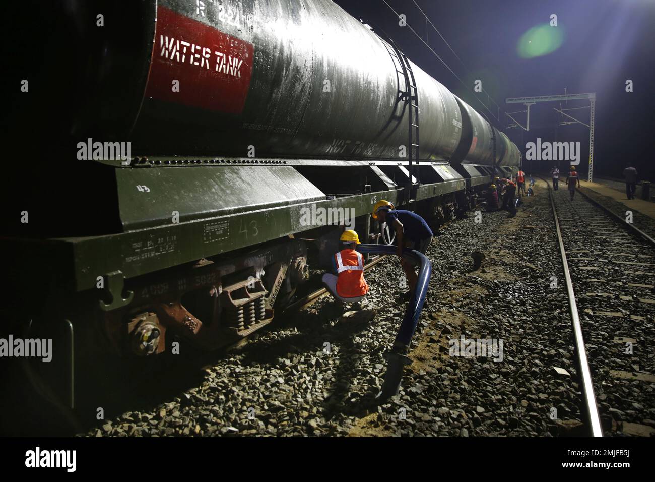 In this Thursday, July 18, 2019, photo, workers attach a blue pipe to ...
