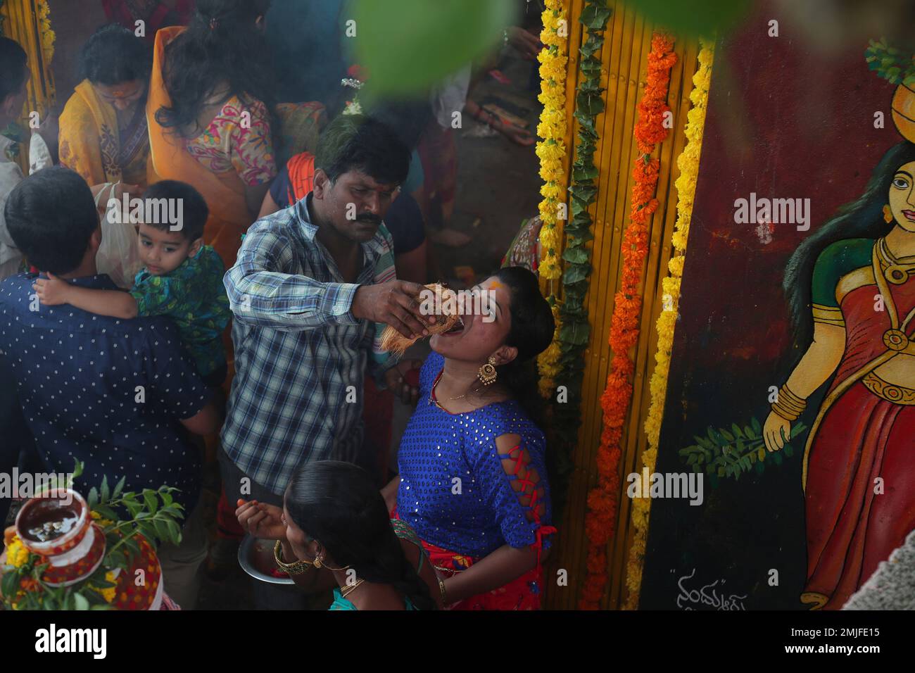 An Indian devotee drinks coconut water after braking the shell during ...