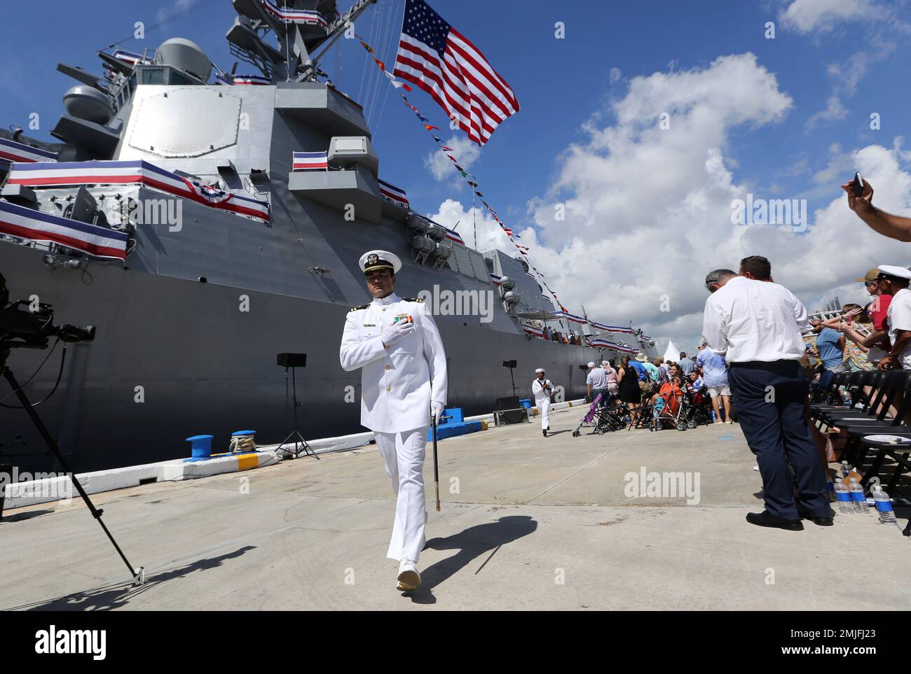 A sailor participates during a commissioning ceremony for the U.S. Navy ...