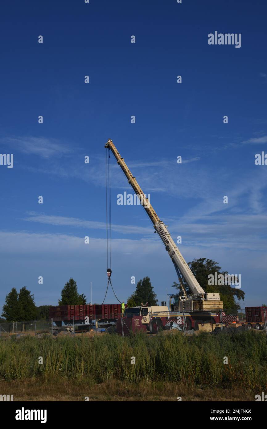 A crane removes a 10-ton load as contractors end a load test, where a ...