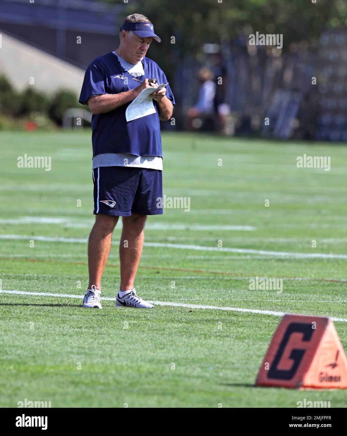 New England Patriots head coach Bill Belichick makes notes during an ...